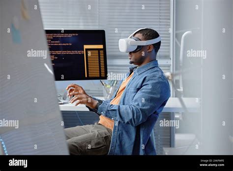 Side View Shot Of Male African American Software Developer Testing Vr