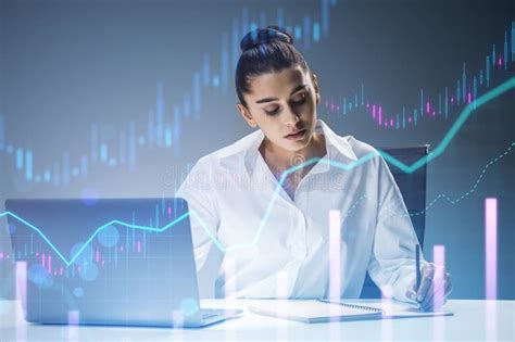 A Focused Woman Analyzing Financial Data Graphs Overlaid On Her Workspace Symbolizing Analytics