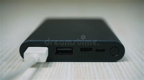 Black Power Bank In Process Of Charging Four Little Indicator Lights