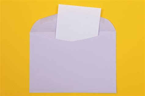 내부에 빈 흰색 종이가 있는 보라색 봉투 프리미엄 사진