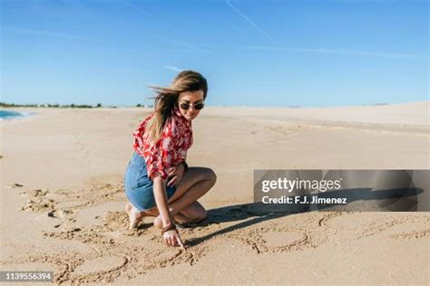 Woman Beach Write Photos And Premium High Res Pictures Getty Images