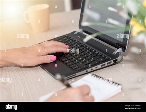 Female Hands Taking Notes On A Notebook And Working On Laptop Light Effect Stock Photo Alamy