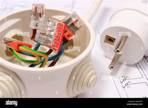 Copper Wire Connections In Electrical Box And Electric Plug Lying On Construction Drawing Of