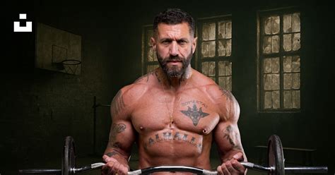 Man Performs Bicep Curls With Weights In The Gym Photo Free Workout Image On Unsplash