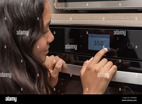 Close Up Teenager Setting The Temperature In The Digital Oven Stock Photo Alamy