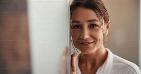 흰색 목욕 가운에 검은 눈을 가진 우아한 아름다운 여성의 초상화를 클로즈업하고 실내 방에서 사진 카메라를 보고 있다 사진 Unsplash의 사진술 이미지