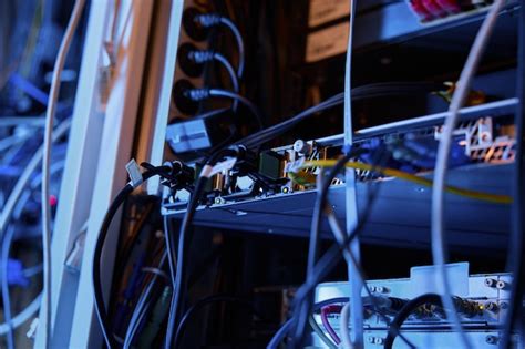 Premium Photo Closeup Wires And Cables Connected To Hardware Mainframe In Dark Network Server Room