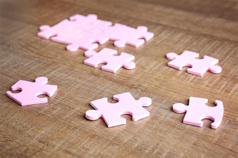 Premium Photo Puzzle Pieces On Wooden Background Unity Concept