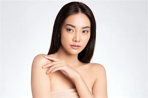 Beautiful Young Asian Woman With Clean Fresh Skin On White Background