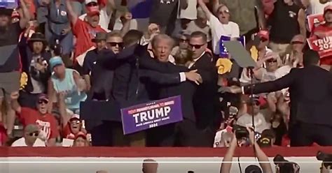 Donald Trump Stands And Raises His Fist In Defiance After Multiple