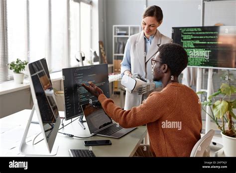 software developers discussing programming code when working on new application for vr headset