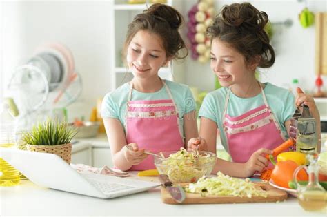 Portrait Of Two Girls Sisters In The Kitchen Cook Stock Image Image Of Europeans Eating