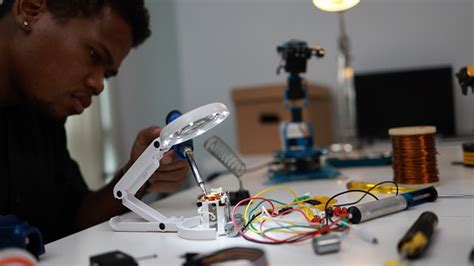 Students Are Repairing And Assembling A Robot Hand While Also Soldering