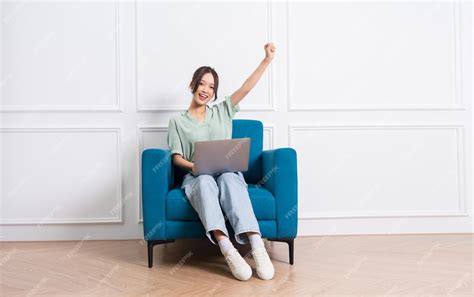 Premium Photo Image Of Young Asian Girl Sitting On Sofa At Home