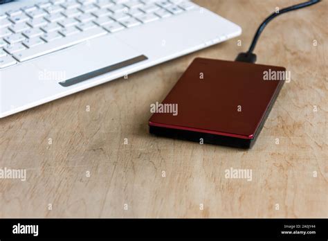 Modern Storage External Hard Drive And Laptop Keyboard On Wooden Table Background Device For