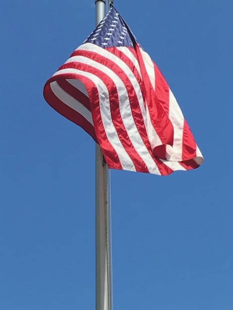 Premium Photo Low Angle View Of Flag Against Clear Blue Sky