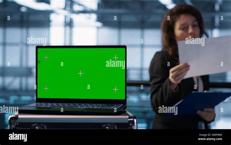 Green Screen Laptop Used By Data Center Admins In Blurry Background