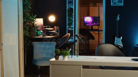 Cozy Dimly Lit Living Room With Ultrawide Smart Tv And Computer Monitor Left Open Late At Night