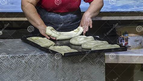 The Baker Hands Are Deftly Working With Raw Uncooked Dough Is Being Shaped Into Various Forms