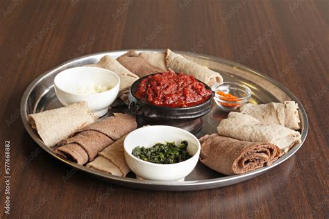 Eritrean Dish Called Kitfo Served With Spinach Cheese And Flatbread Stock Photo Adobe Stock