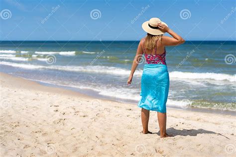 Summer Vacation Tanned Mature Woman In Swimsuit Pareo And Sun Hat