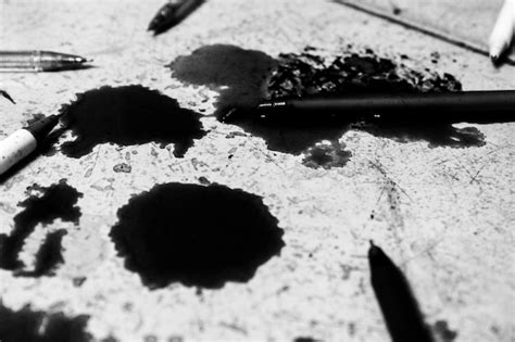 Premium Photo Close Up Of Ink Blobs With Pens On Table