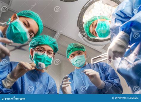 Surgical Team Performing A Cosmetic Surgery In Hospital Operating Room