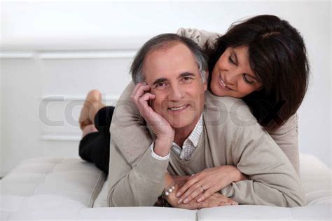 Mature Couple Lying In Bed Showing Their Affection Colourbox