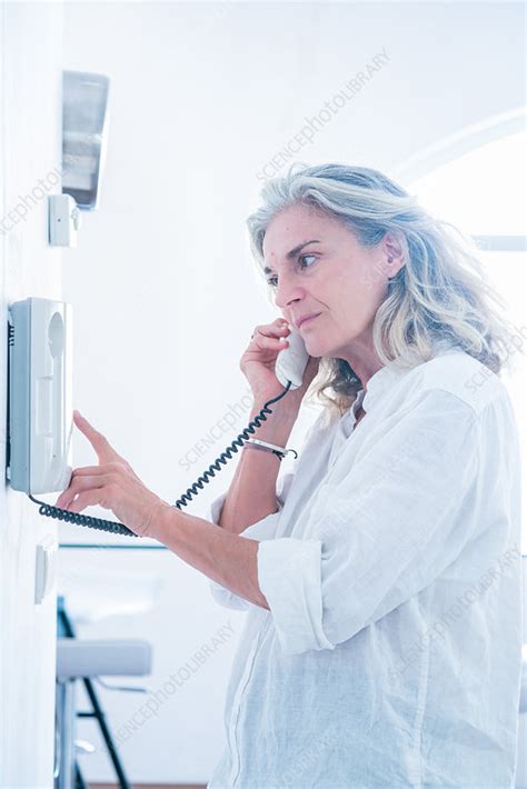 Woman Using An Intercom Stock Image C Science Photo Library