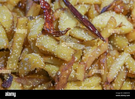 Close Up Image Of Fried Potato Pieces With Fried Red Chilly A Fast Food Dish Popular Amongst