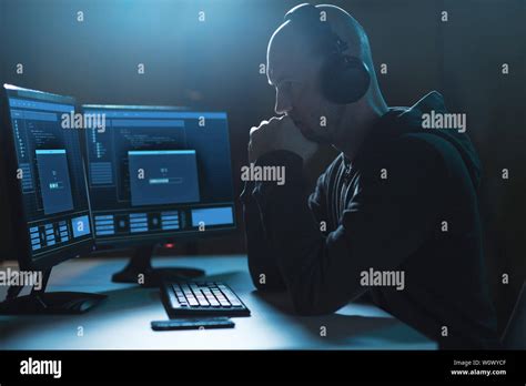 Hacker With Progress Bar On Computers In Dark Room Stock Photo Alamy