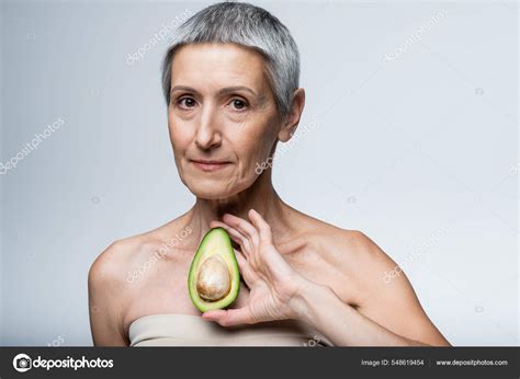 Middle Aged Woman Bare Shoulders Holding Ripe Avocado Isolated Grey