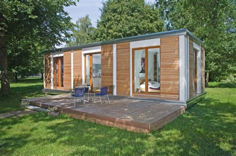 a small wooden cabin sitting on top of a lush green field