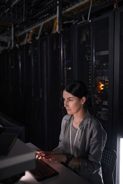 Premium Photo Vertical Portrait Of Female Network Engineer Using Computer While Working In