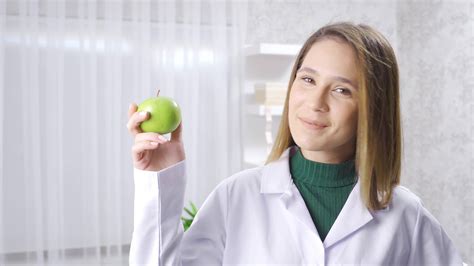 Positive Dietitian Woman Recommends Healthy Eating Shows Fresh Apples