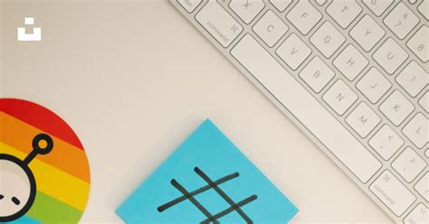 A Desk With A Keyboard Pen And A Book Photo Free Homeoffice Image On Unsplash