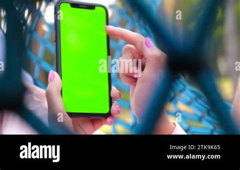 woman resting in a forest camp lying in a hammock and using a