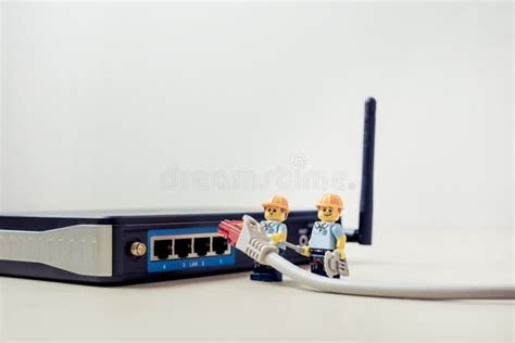 A Close Up View Of A Technicians Connecting Lan Cable Into The Router Illustrative Editorial
