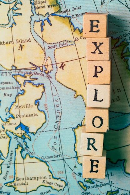 Premium Photo Explore Word Written In Wooden Blocks On A Vintage Travel Map