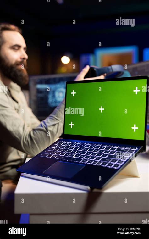 Programmer Updating Artificial Intelligence Algorithm Using Green Screen Laptop Making It