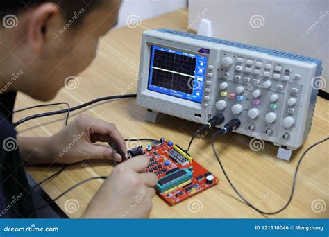 Electronic Devices And Circuit Board ï¼Œmale Electronic Engineer Using Oscilloscope In