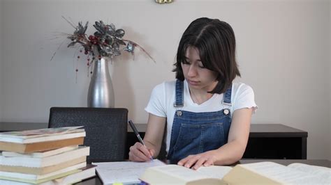 Girl Taking Notes Examining Different Stock Footage SBV Storyblocks