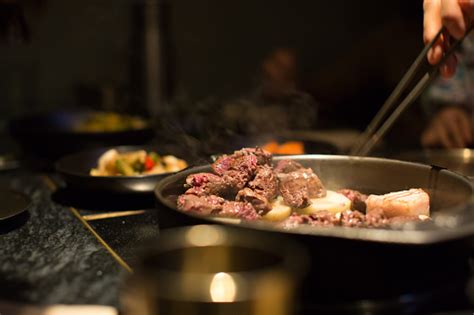 냄비에 감자 튀김 고기를 요리 무 쇠 프라이팬 바닥에 튀긴 쇠고기 스테이크 저녁 식사 준비 요리 그릴 팬에 준비 된 신선한 쇠고기 고기의 큰 조각 단백질이 풍부한 영양