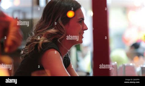 Night Scene Of Candid Casual Young Women Seen Through Window At