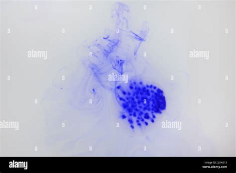 Drops Of Ink Flowing Through Water Stock Photo Alamy