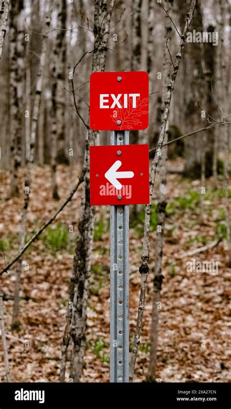 A Red Exit Sign On A Trail Indicating The Correct Exit Route Stock