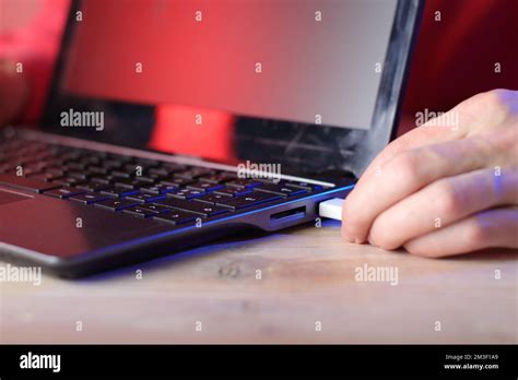 Inserting Usb Cable Into Laptop On Table And Colored Background Stock Photo Alamy