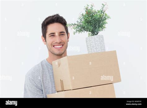 Handsome Man Holding Boxes Because He Is Moving Stock Photo Alamy