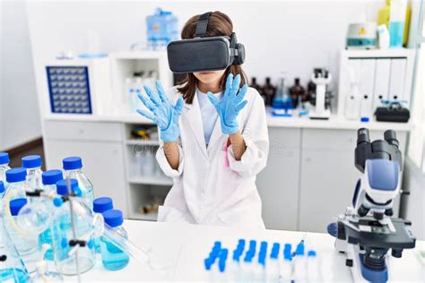 Young Hispanic Girl Wearing Virtual Reality Glasses At Laboratory Stock