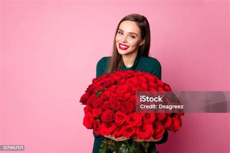 사진 제공 매력적인 매력적인 레이디 레드 밝은 립스틱 제공 큰 백 장미 꽃다발 엄마 엄마 8 행진 선물 착용 그린 드레스 고립 된 파스텔 핑크 컬러 배경 갈색 머리에 대한
